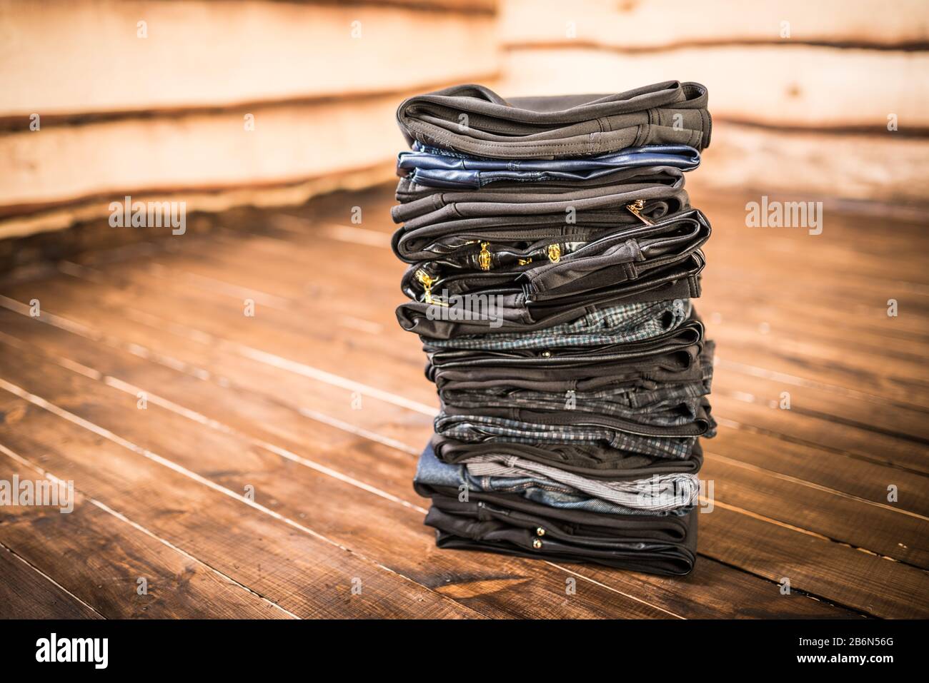 Black women's trousers lie against the background of a pile with dark ...