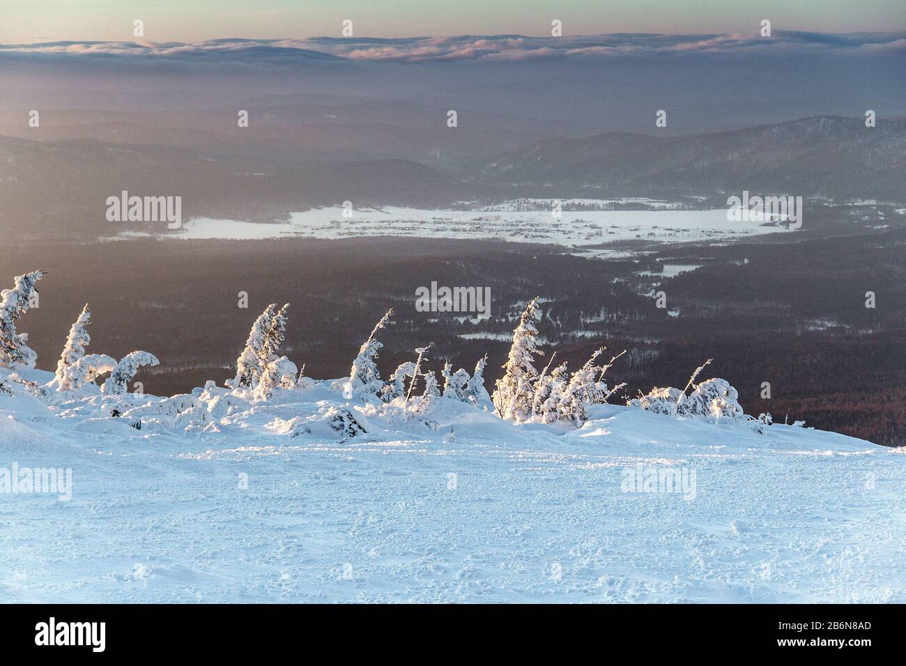 Winter landscape with distant village with small houses covered with ...