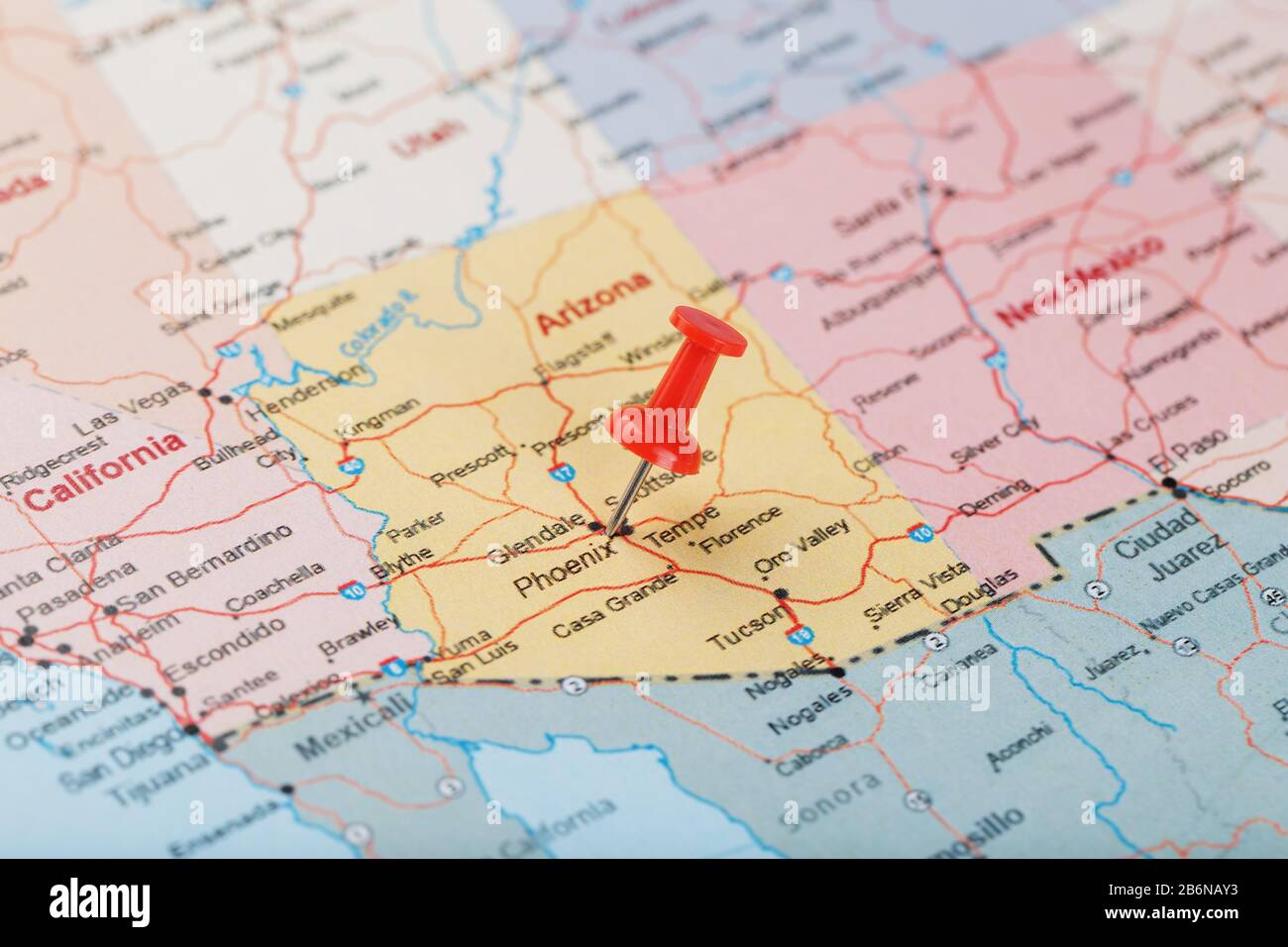 Red clerical needle on a map of the USA, Arizona and the capital ...