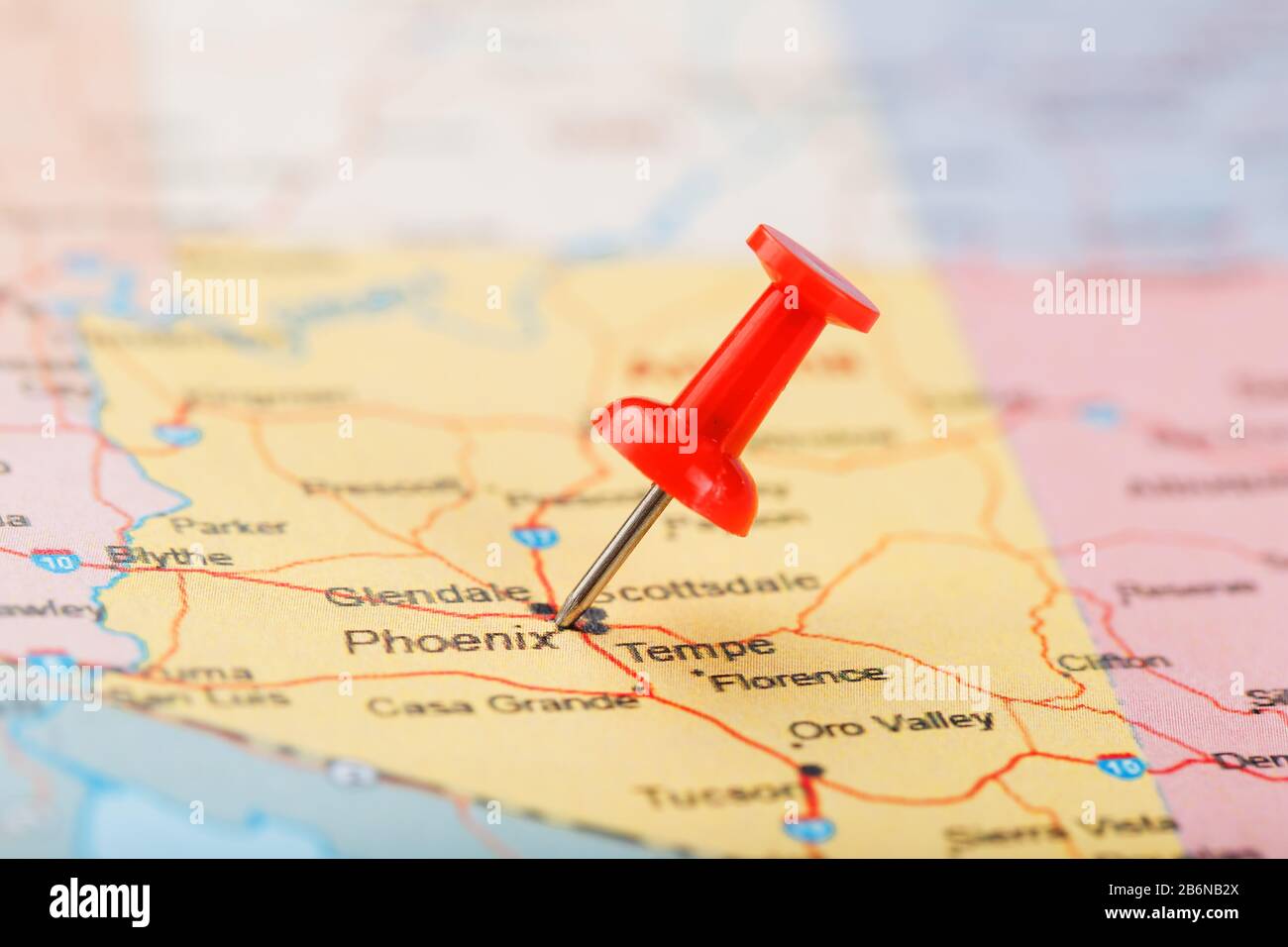Red clerical needle on a map of the USA, Arizona and the capital ...