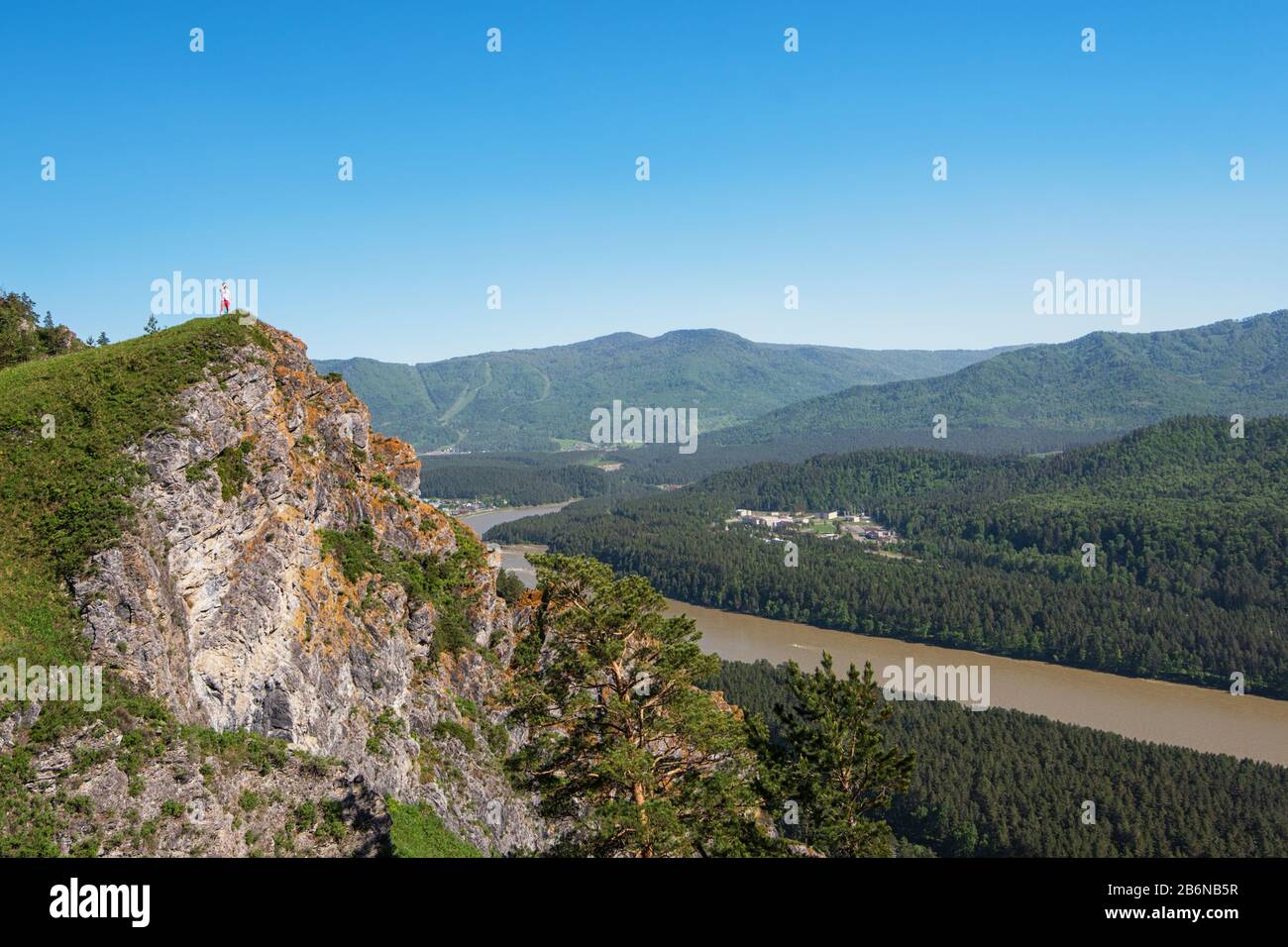 Man standing on top of cliff Stock Photo - Alamy