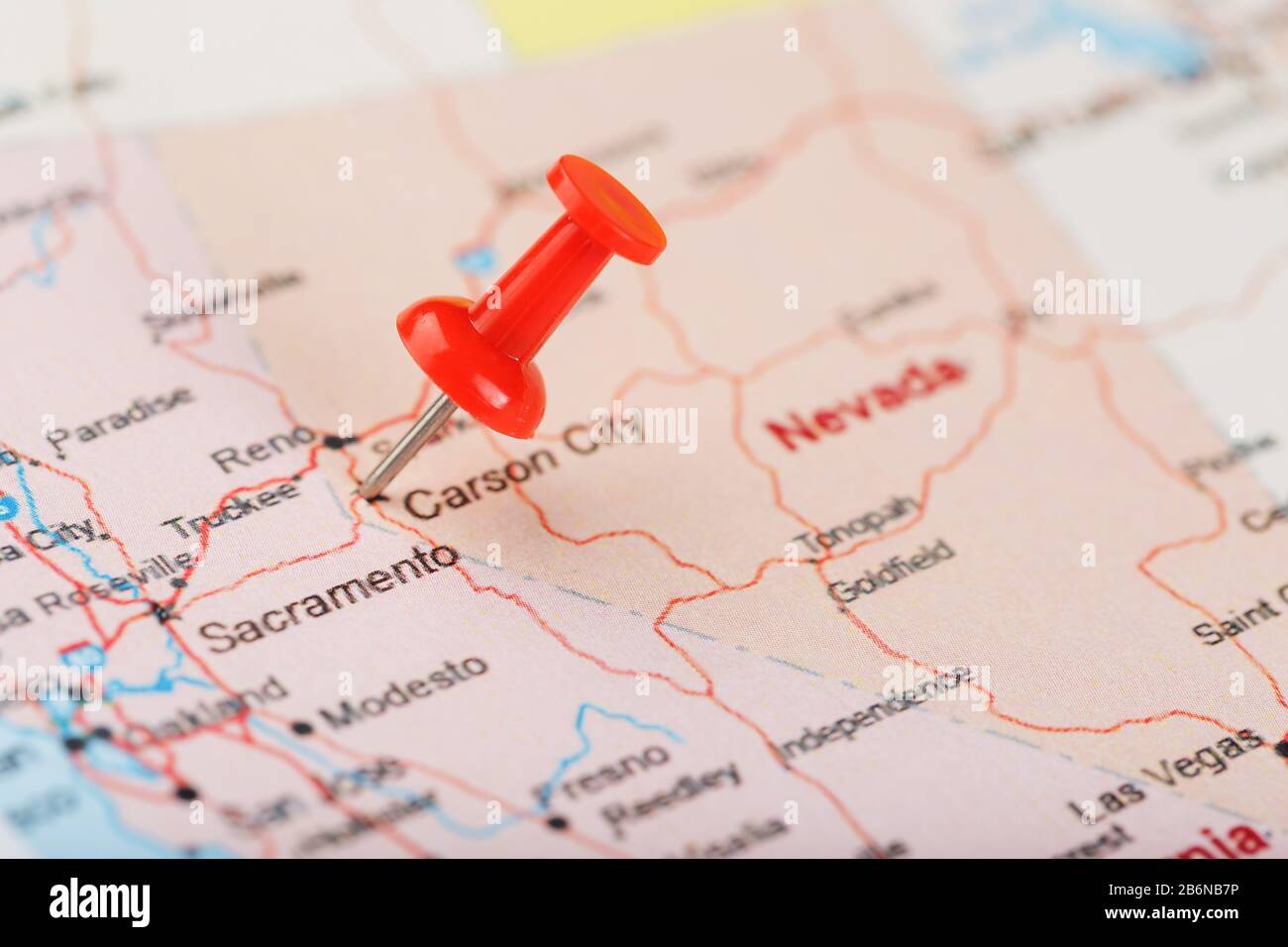 Red clerical needle on a map of USA, Nevada and the capital Carson City ...