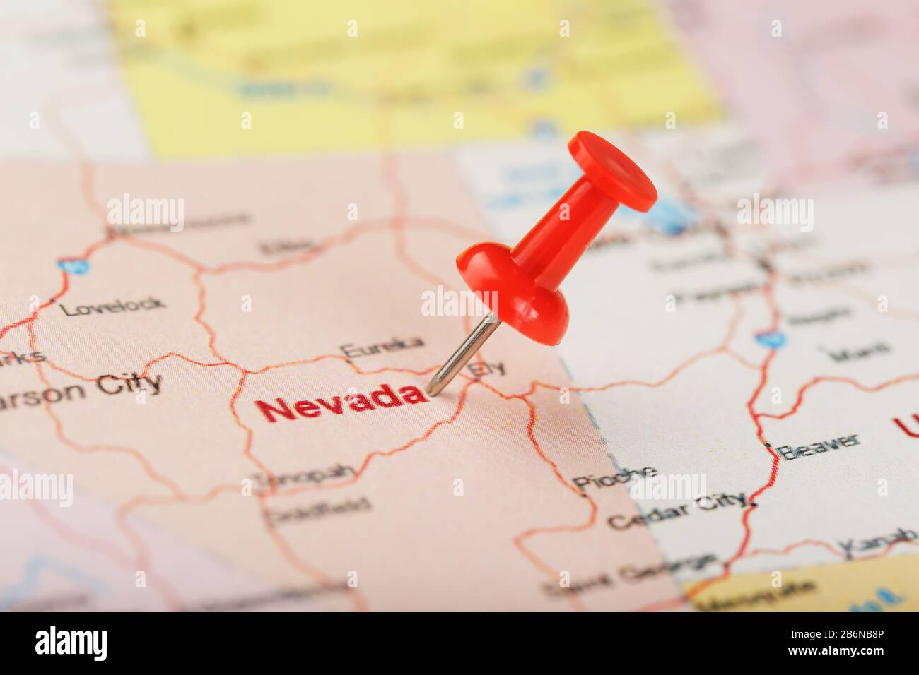 Red clerical needle on a map of USA, Nevada and the capital Carson City ...
