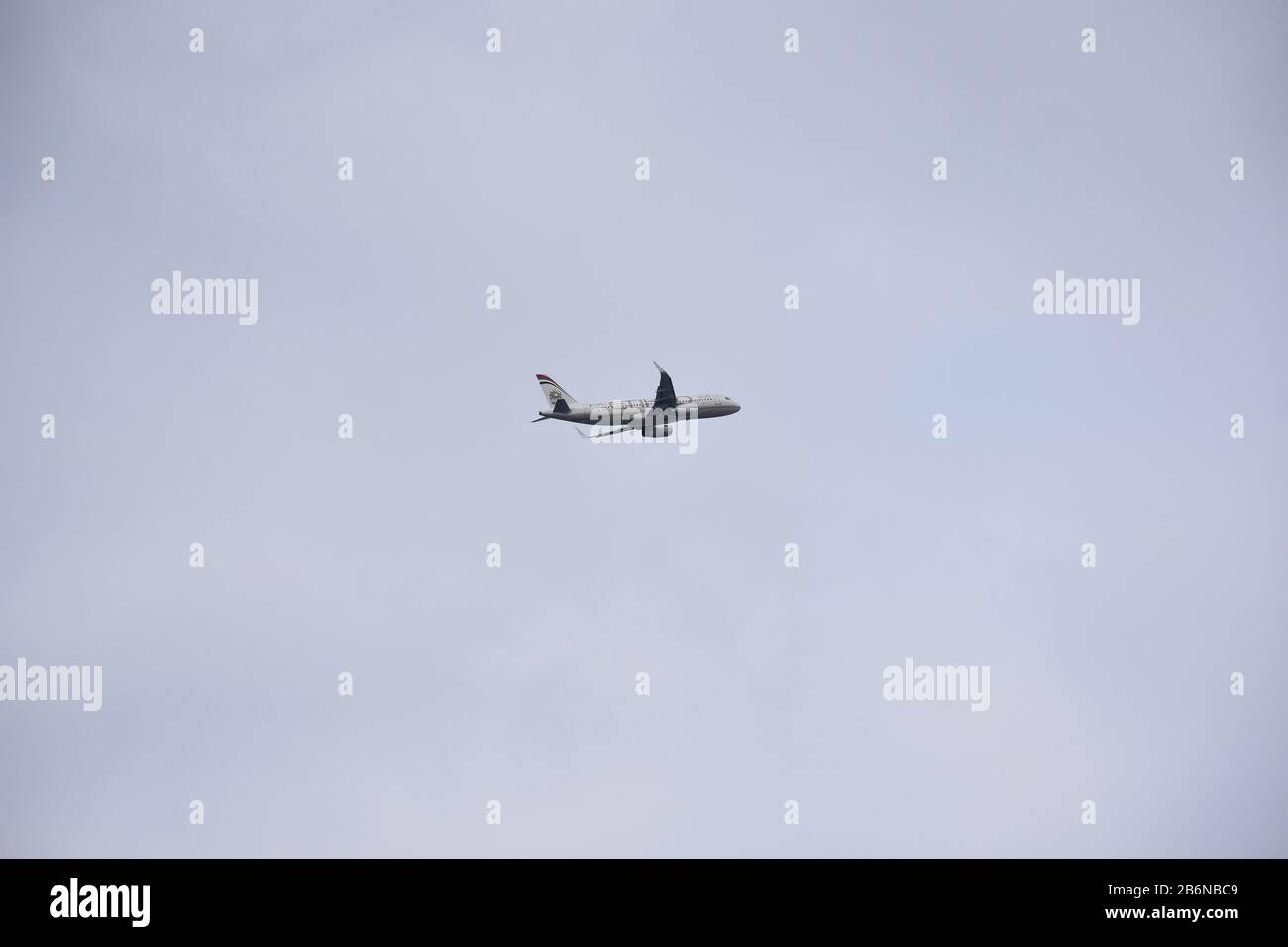 Gray plane in flight with gray cloudy background Stock Photo - Alamy