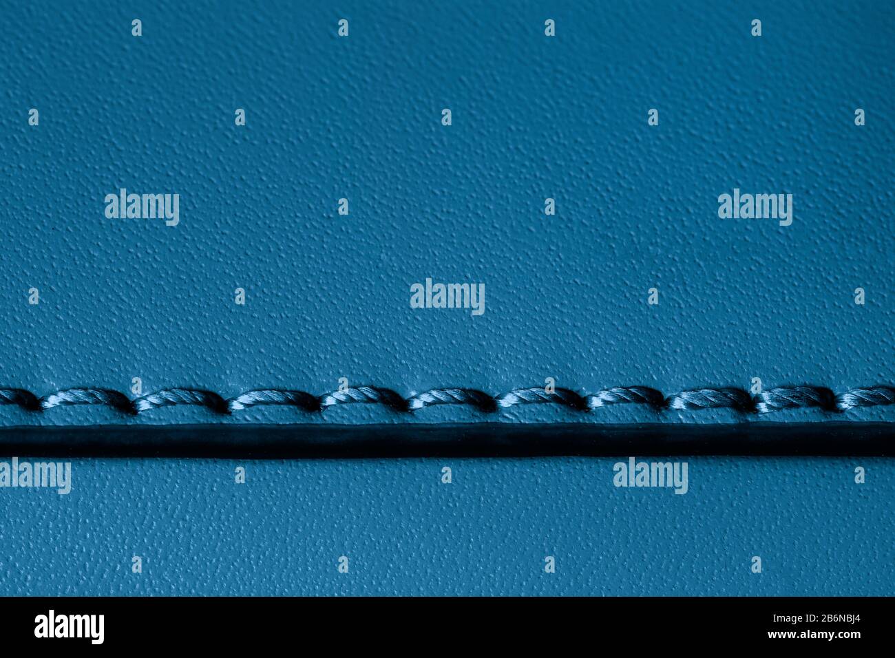 Texture of blue genuine leather sewn with stitch. For fashionable ...