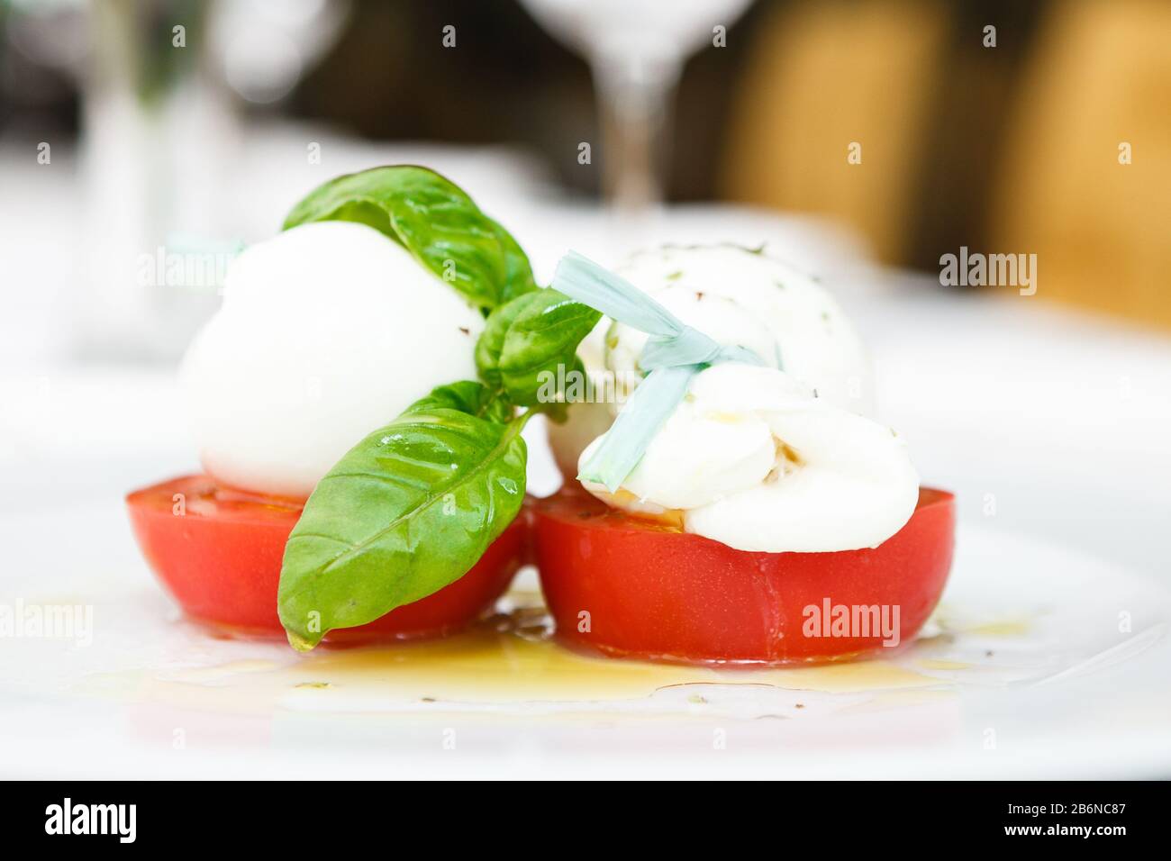 Mozarella cheese with tomatoes served on a plate Stock Photo - Alamy