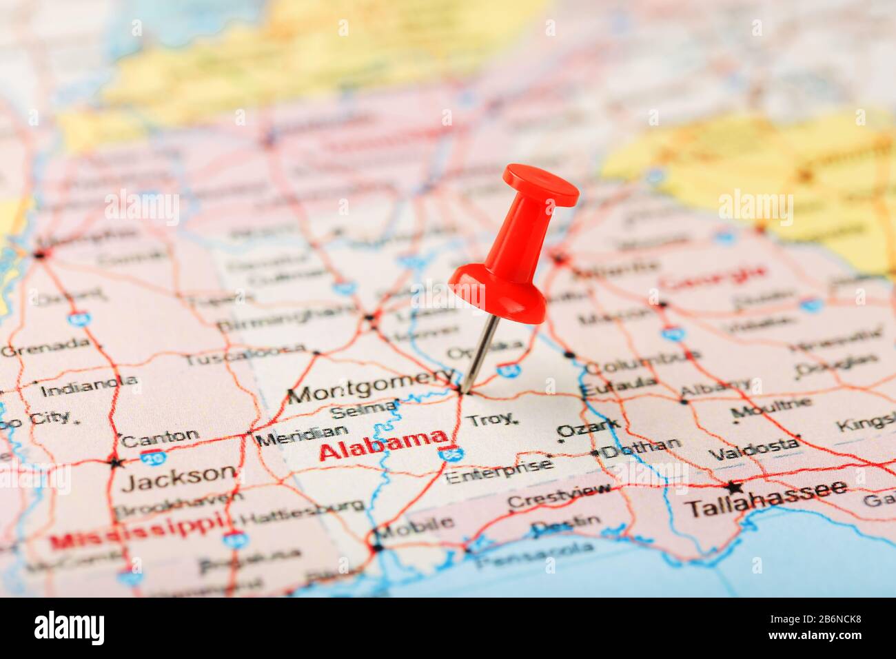 Red clerical needle on a map of USA, South Alabama and the capital ...