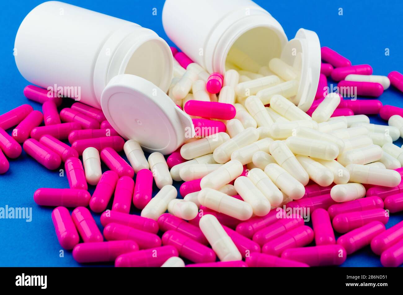 White capsules on blue background hi-res stock photography and images ...