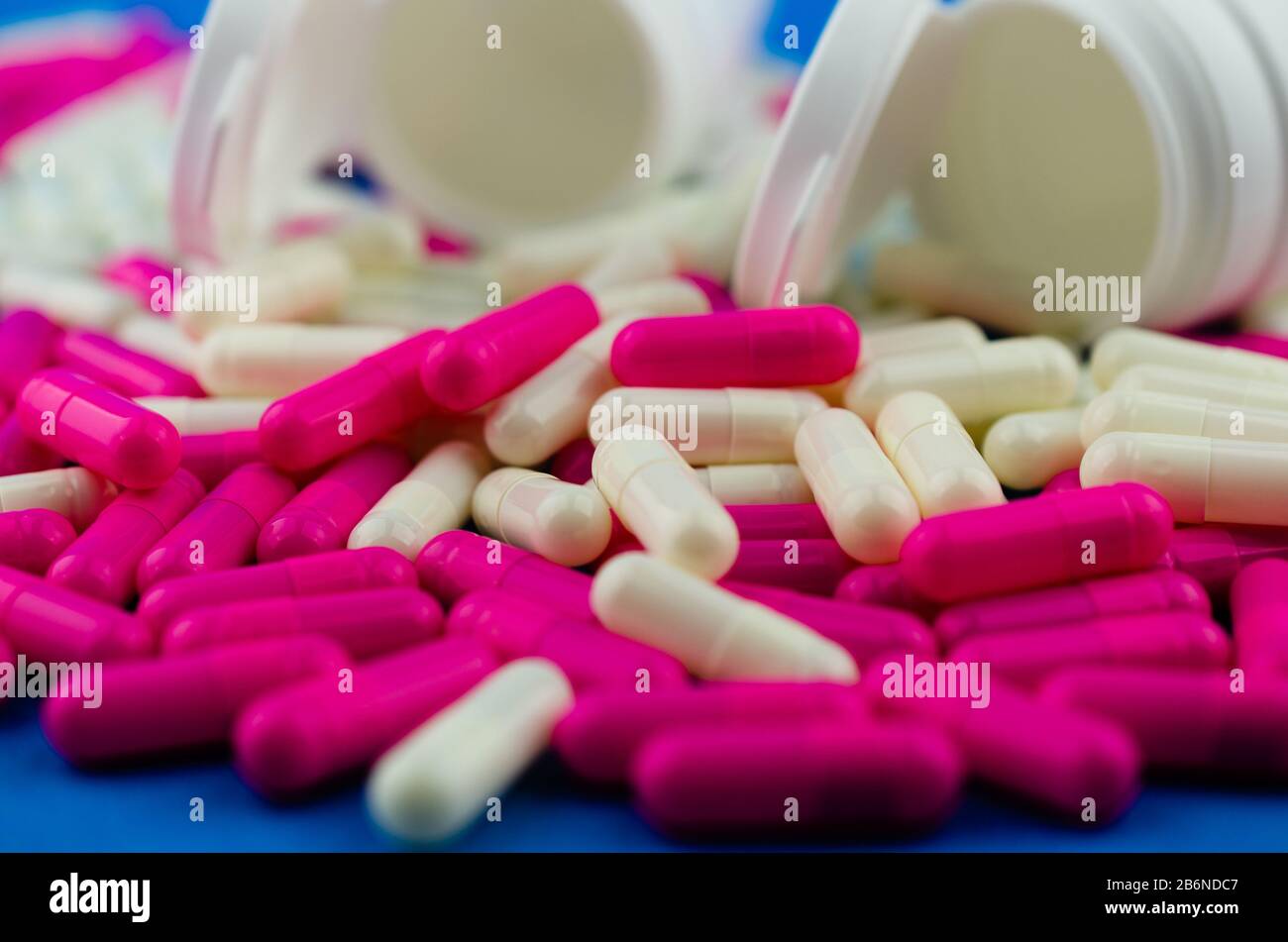 White capsules on blue background hi-res stock photography and images ...