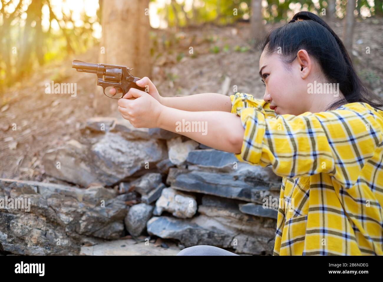 Young woman aiming revolver hi-res stock photography and images - Alamy