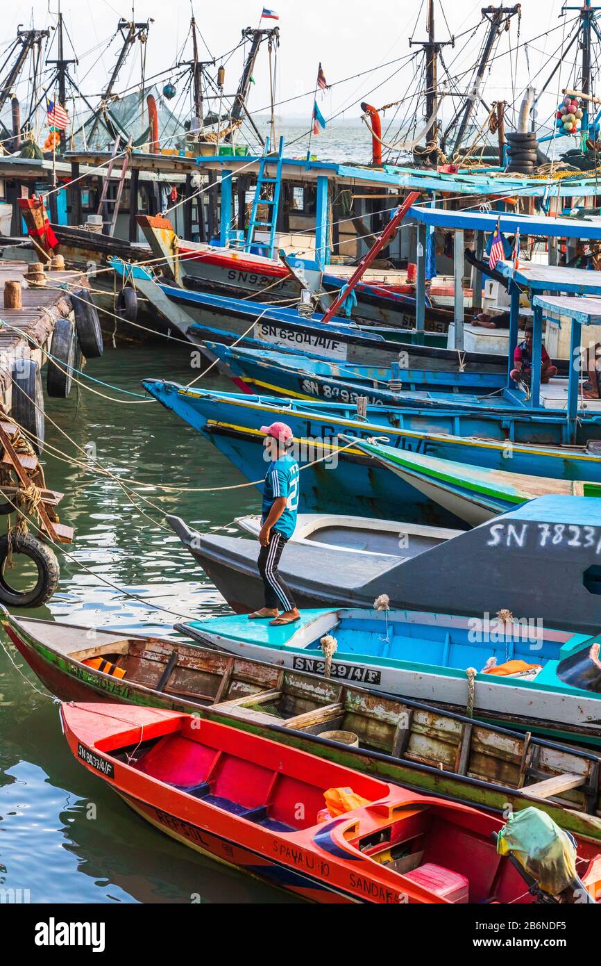 Fishing boats and fishermen in the harbour at Sandakan, Sabah District ...