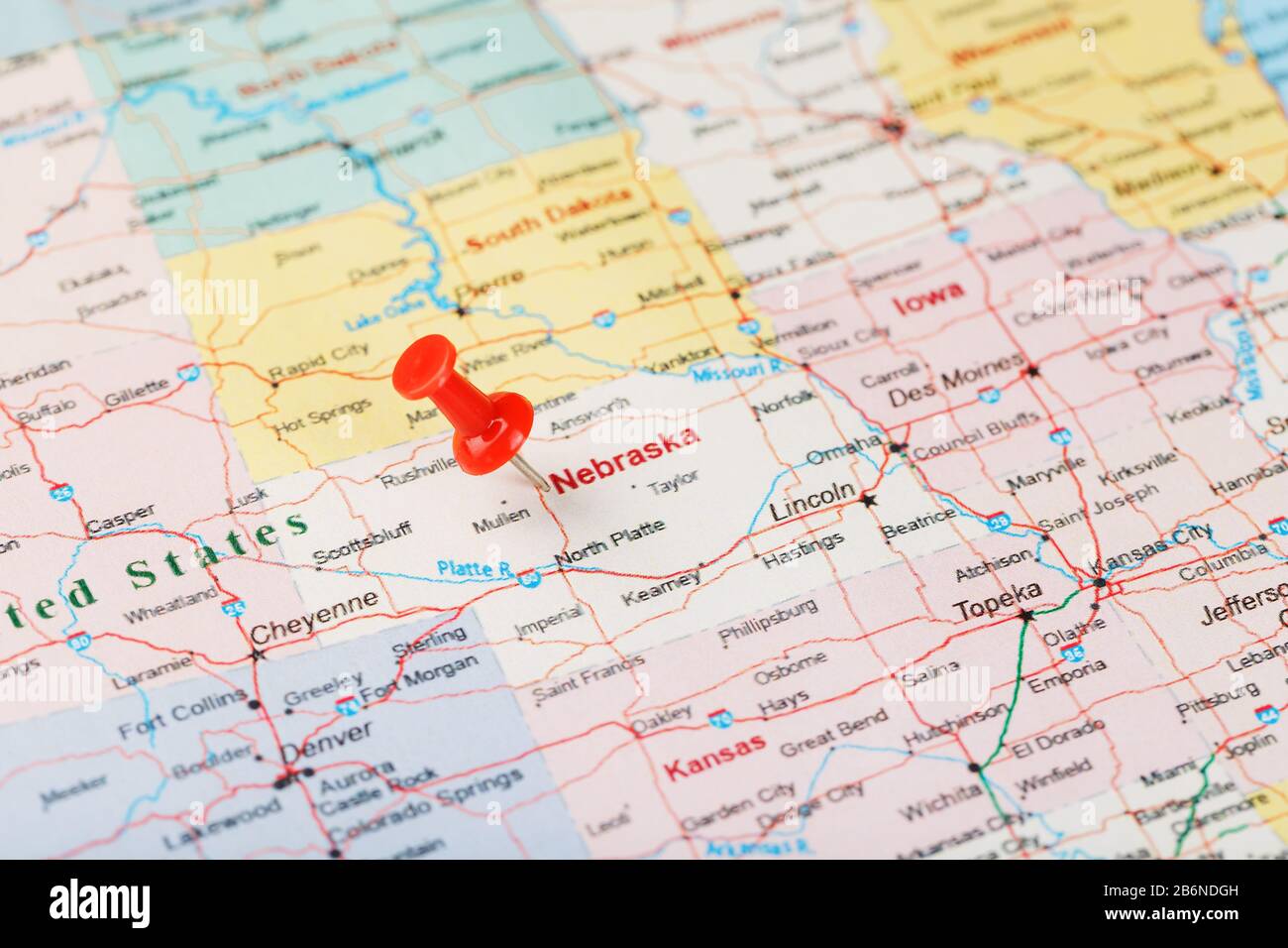 Red clerical needle on a map of USA, Nebraska and the capital Lincoln ...