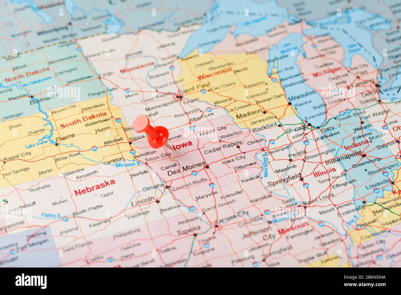 Red clerical needle on a map of USA, Iowa and the capital Des Moines ...