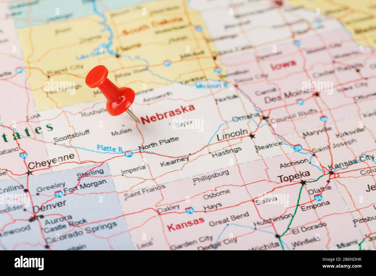 Red clerical needle on a map of USA, Nebraska and the capital Lincoln ...