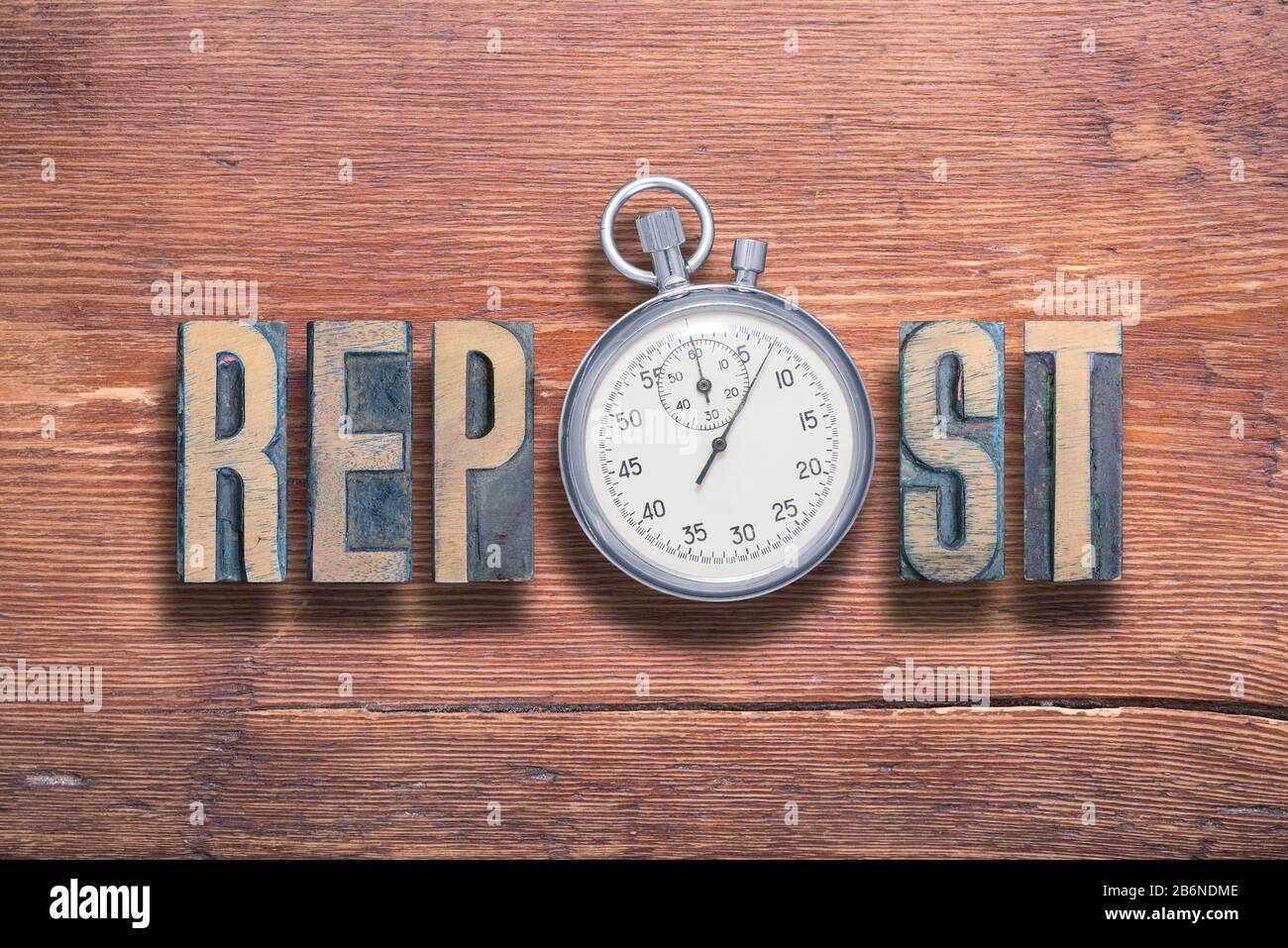 repost word combined on vintage varnished wooden surface with stopwatch ...