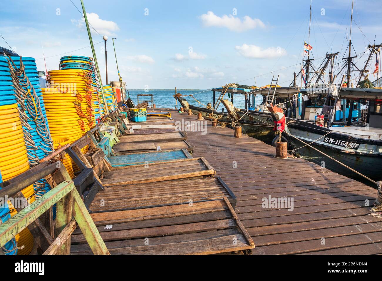 Fishing boats and fishermen in the harbour at Sandakan, Sabah District ...
