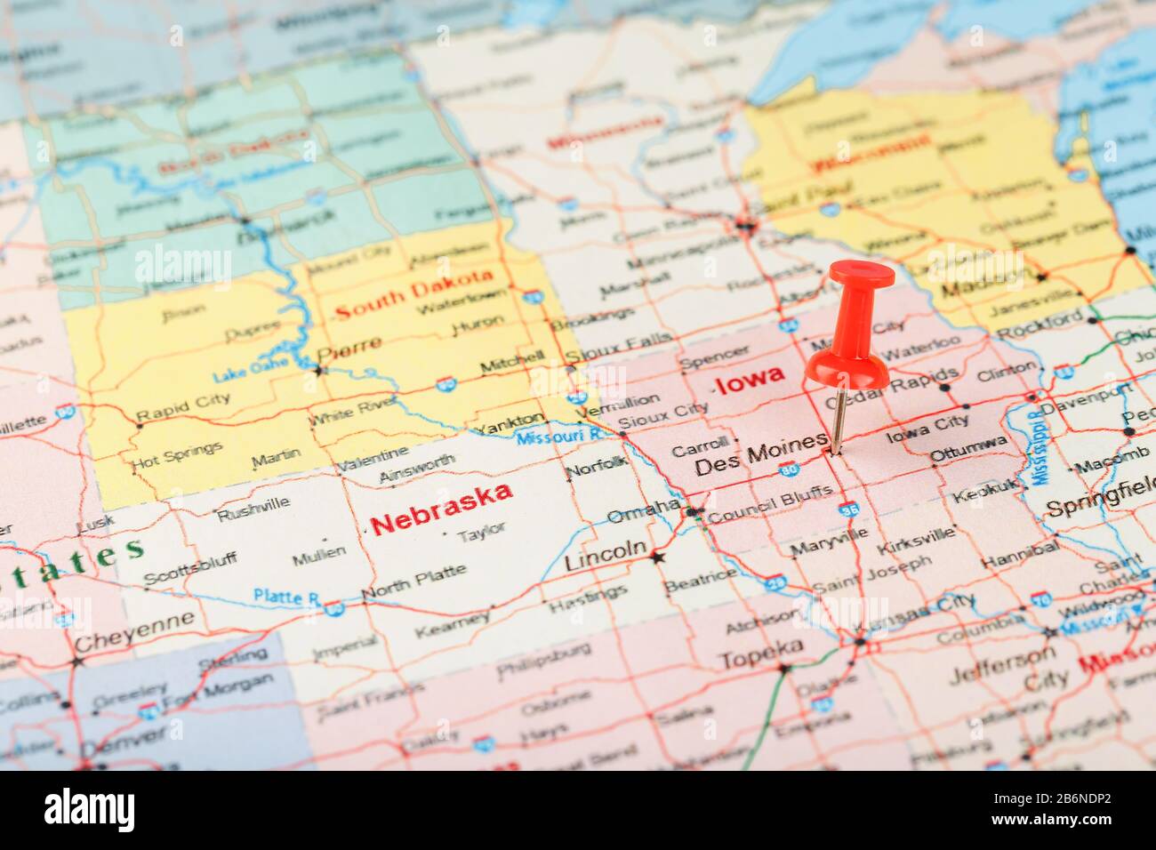 Red clerical needle on a map of USA, Iowa and the capital Des Moines ...
