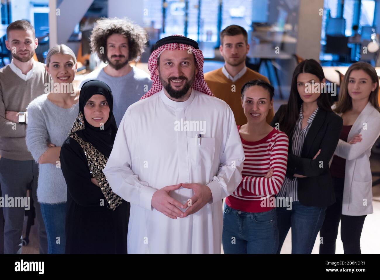 Portrait of young pretty successful multi-ethnic corporate close-knit ...