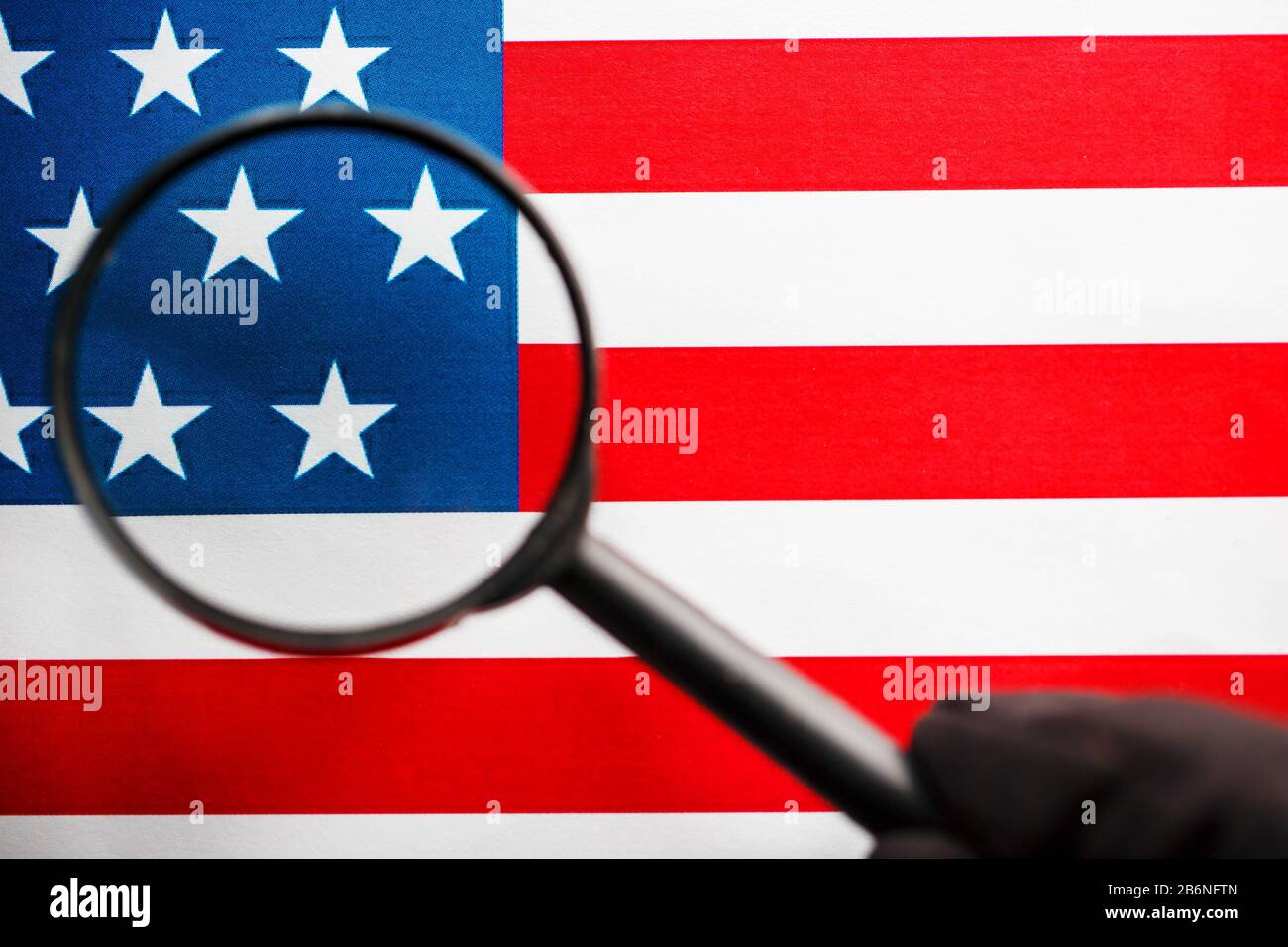 US flag looking through a magnifying glass. Study of the history and ...