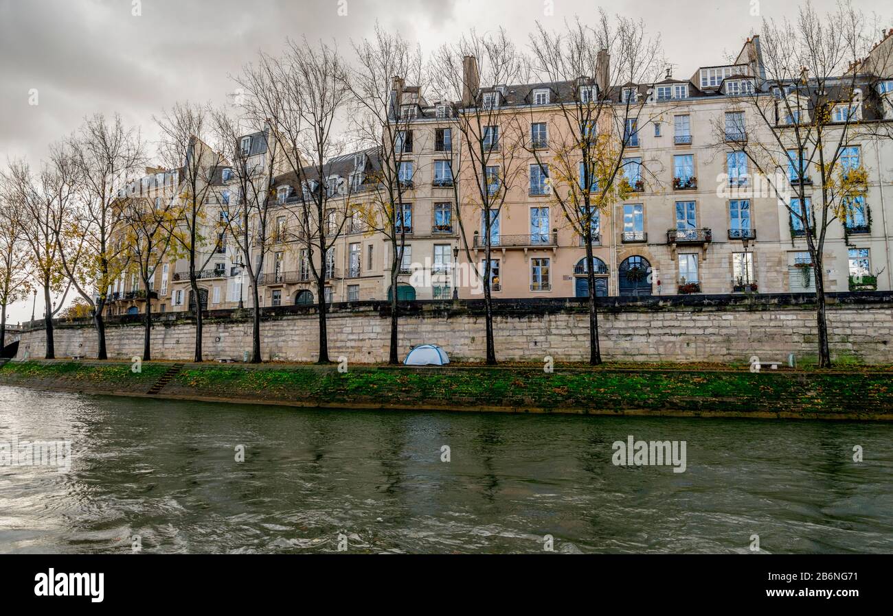 Residential buildings and trees without leaves on river Seine in Paris ...