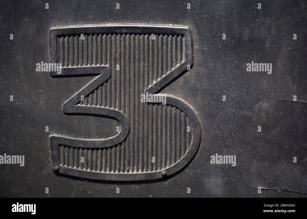 detail of the number "3" engraved on a wheel of a vehicle Stock Photo ...