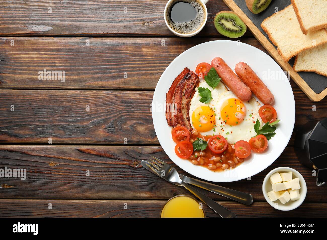Delicious breakfast or lunch with fried eggs on wooden background, top ...