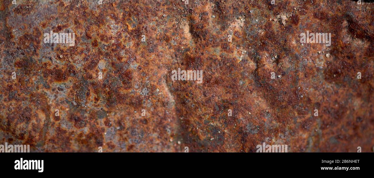 detail of a piece of abandoned rusty sheet metal with copper color and ...