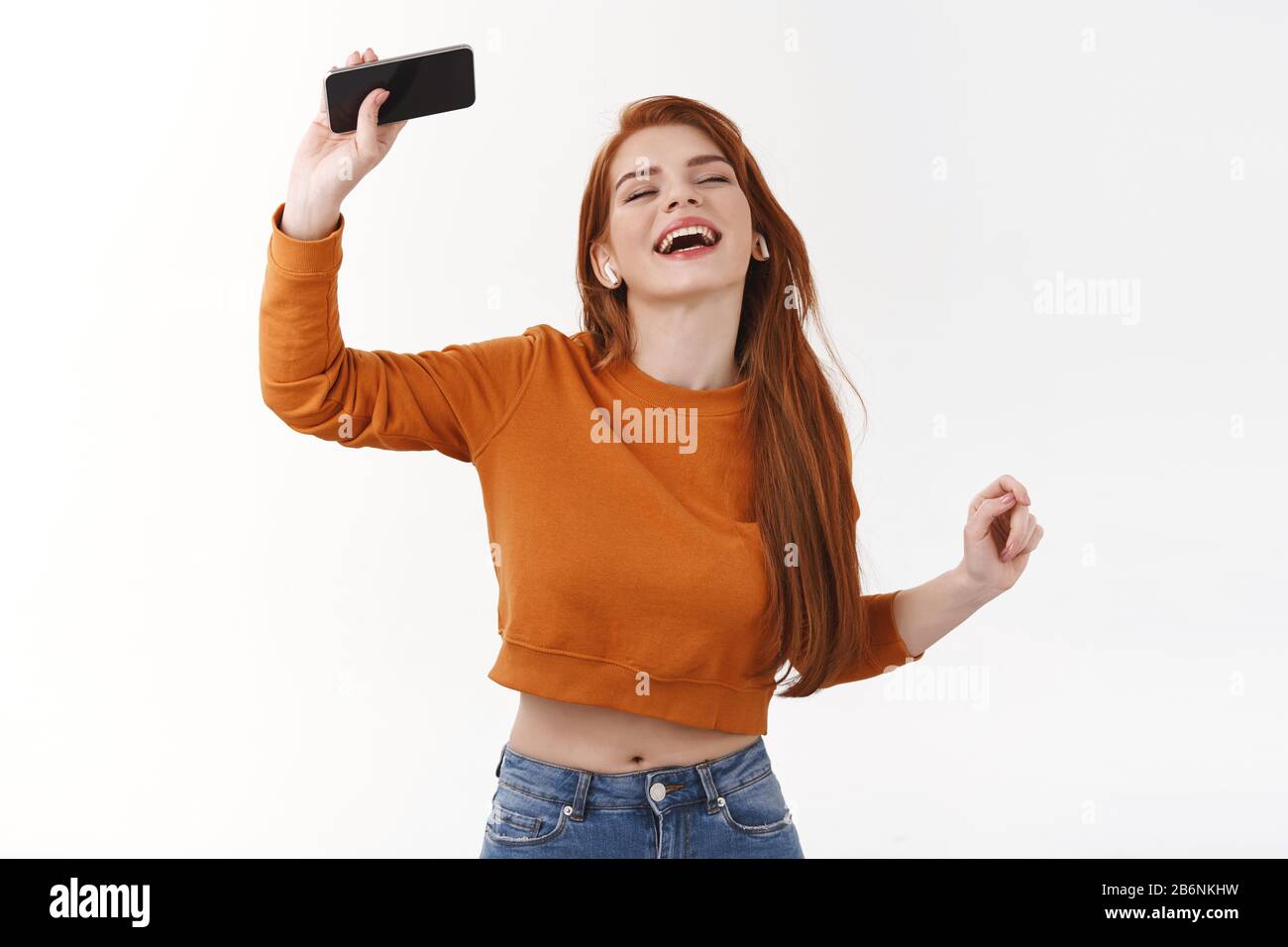 Joyful And Relaxed Carefree Redhead Hipster Girl Carried Away With