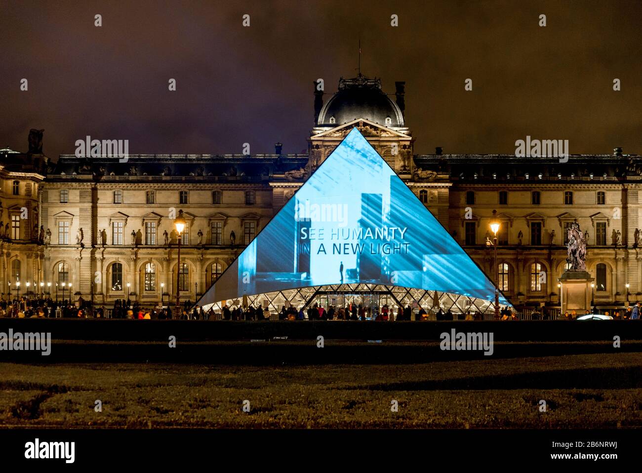 A light presentation displayed on a glass pyramid entrance of Louvre ...
