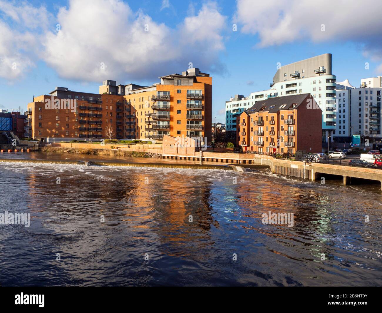 Modern apartment buildings by the River Aire in spate due to recent ...