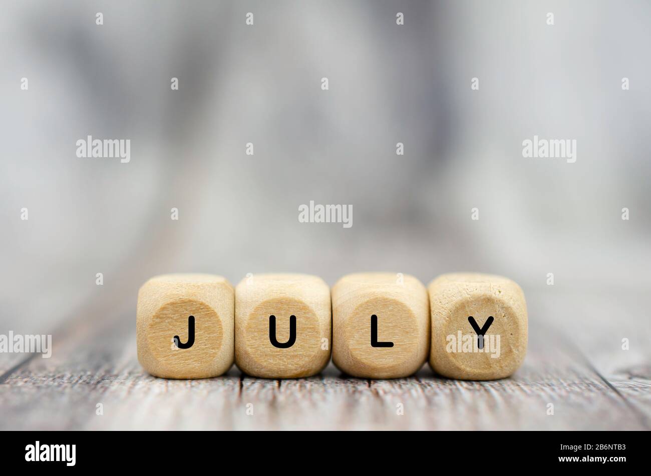 The word July on wooden cubes. Month of year Stock Photo - Alamy