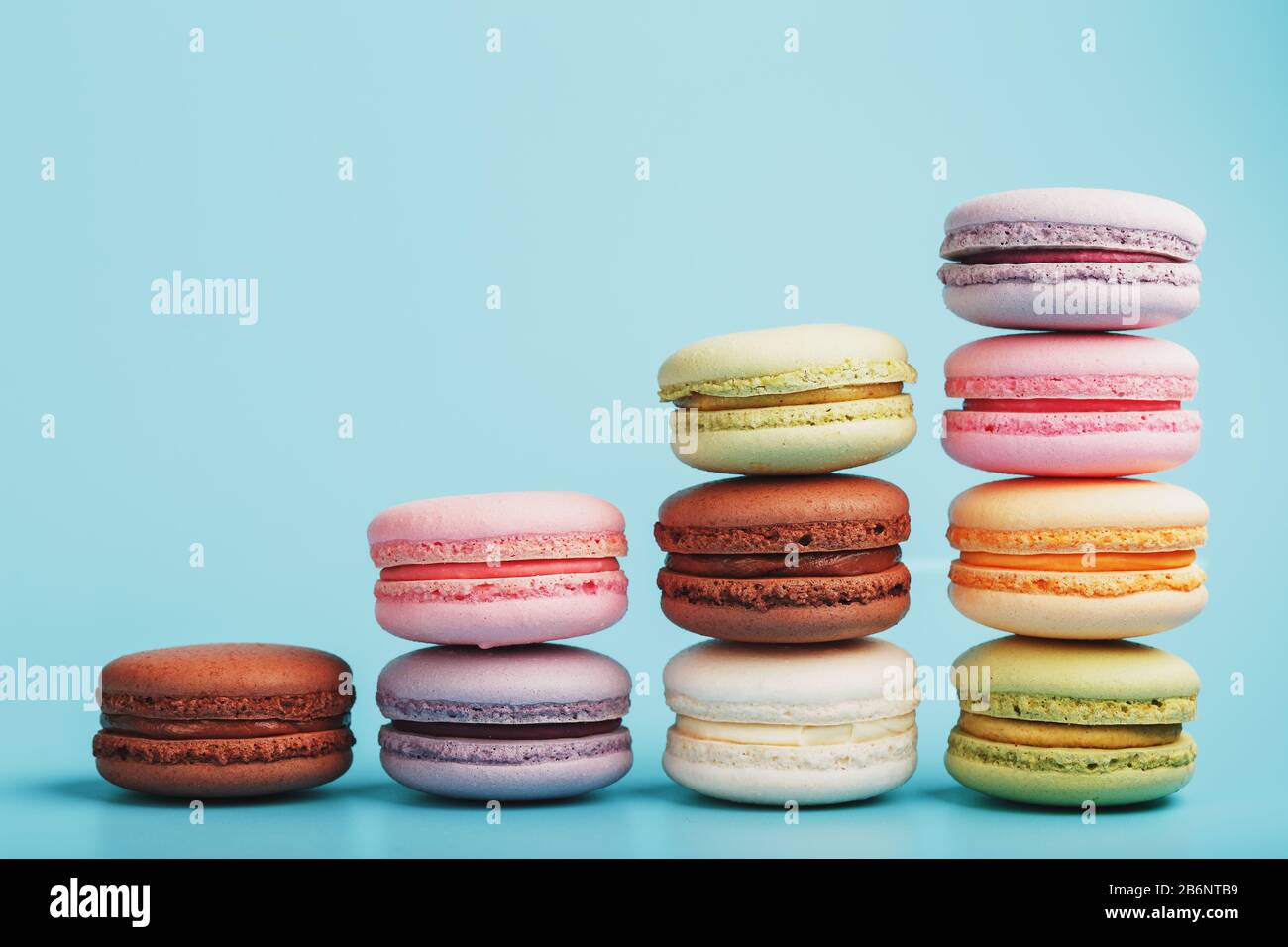 Macaroni cookies of different colors are arranged in the shape of ...