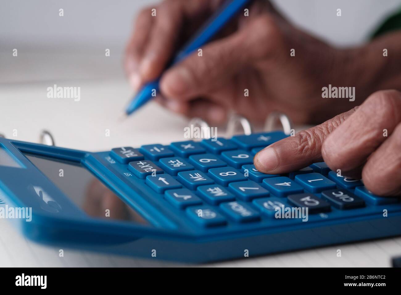 senior women use calculator and writing on notepad Stock Photo - Alamy