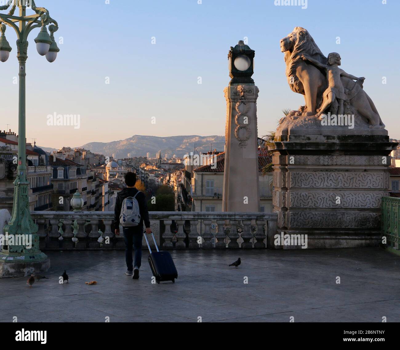 Male model standing on a terrace in France overlooking Marseille in the ...