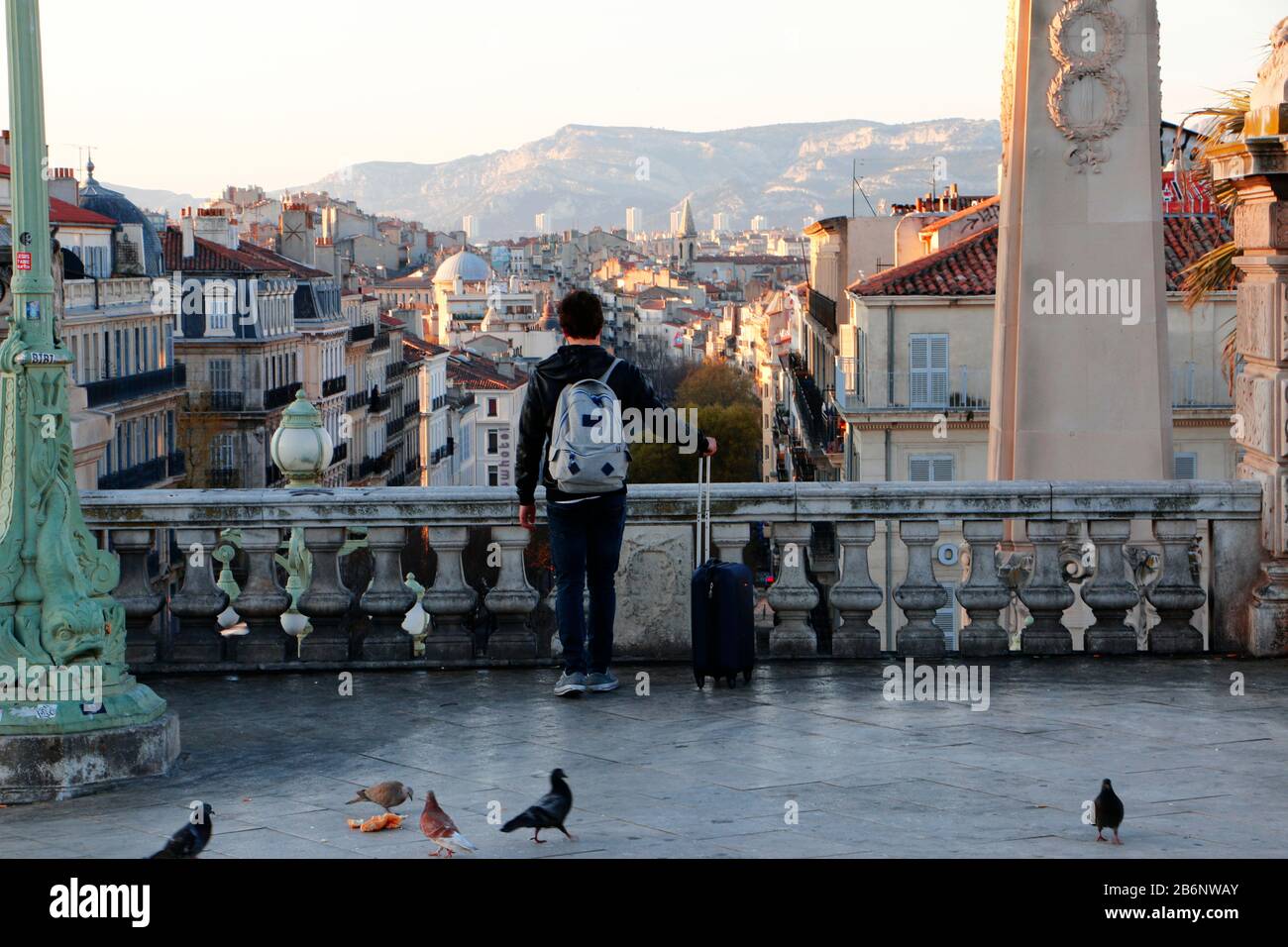 Male model standing on a terrace in France overlooking Marseille in the ...
