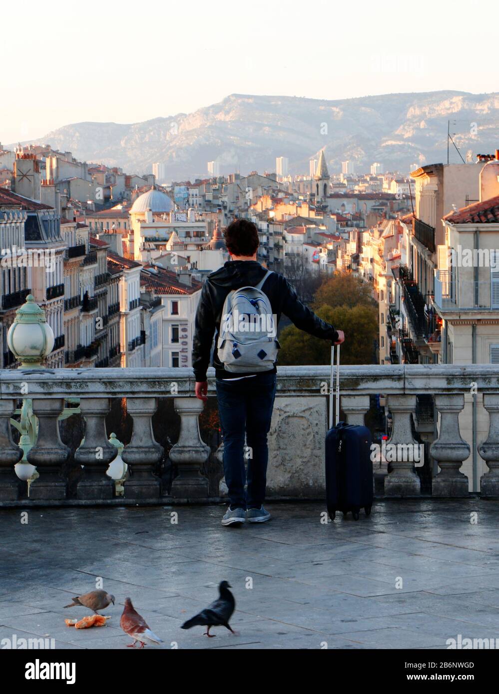 Male model standing on a terrace in France overlooking Marseille in the ...