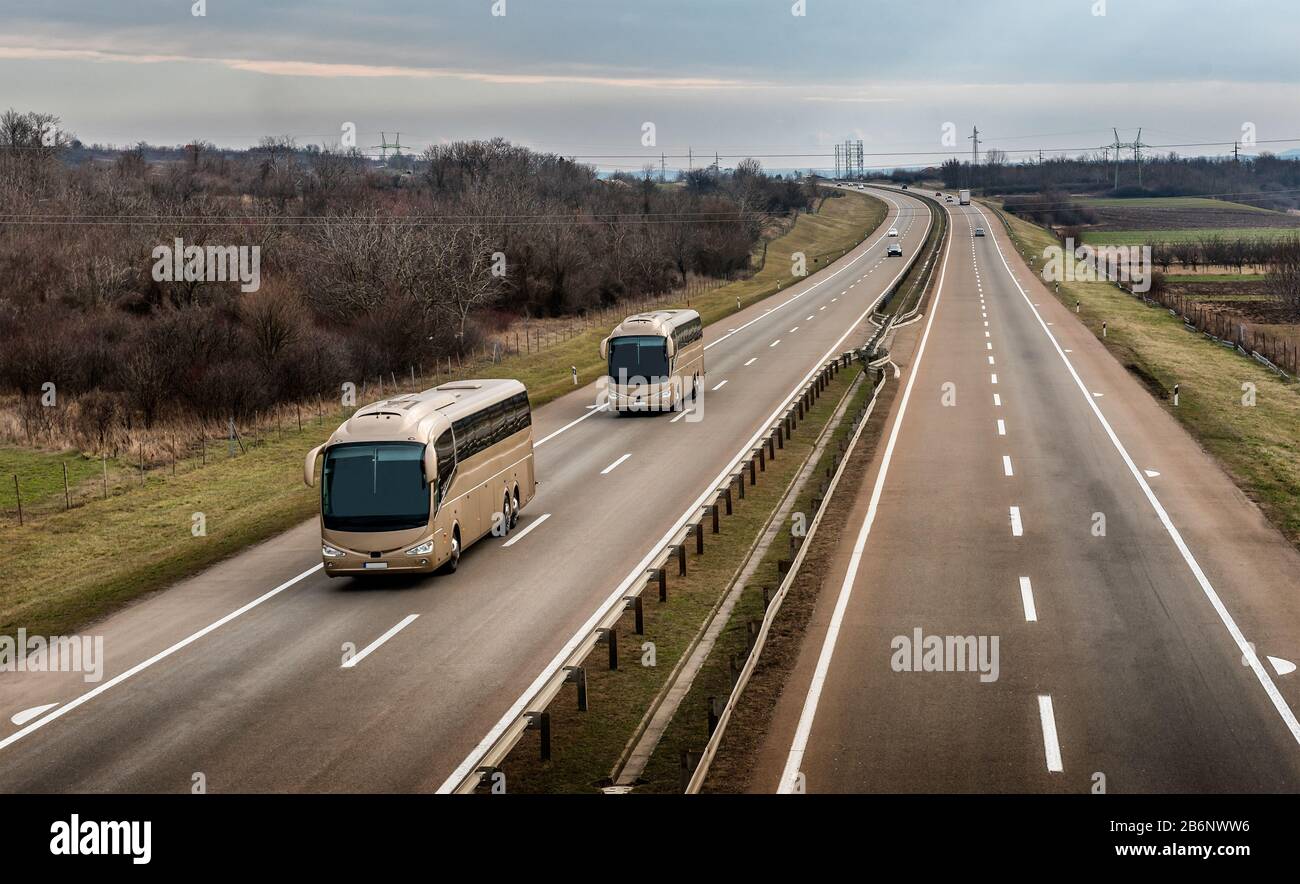 Two buses in line traveling on a highway country highway Stock Photo ...