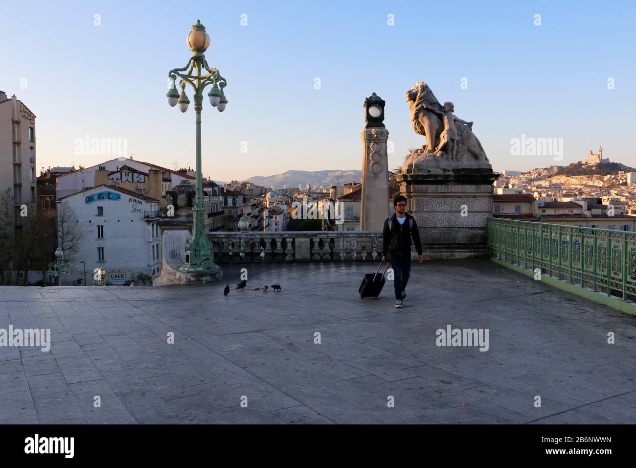 Male model standing on a terrace in France overlooking Marseille in the ...