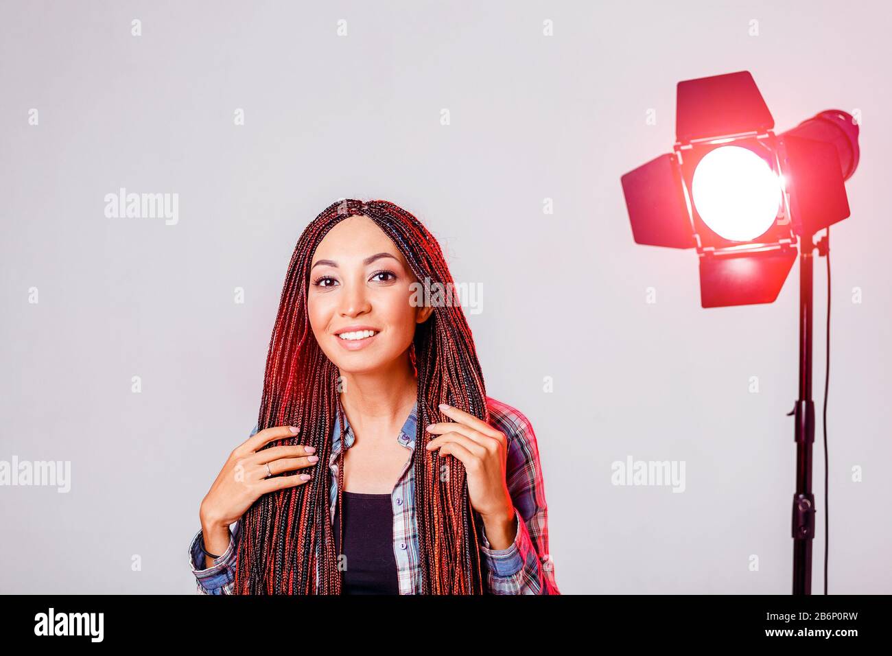 Portrait of beautiful young woman with modern braids ready for photo ...