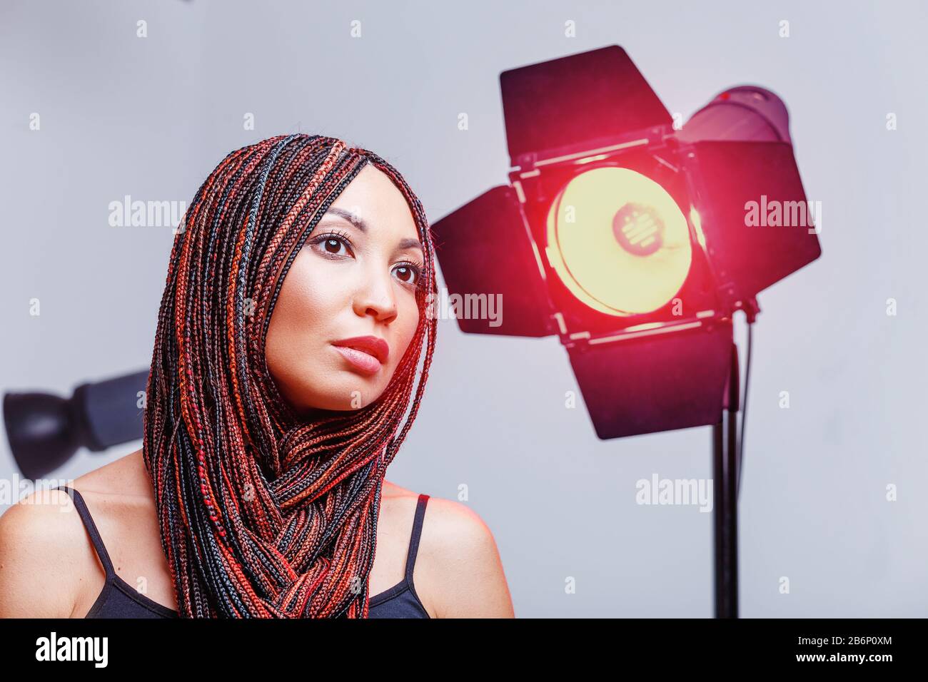 Portrait of beautiful young woman with modern braids ready for photo ...