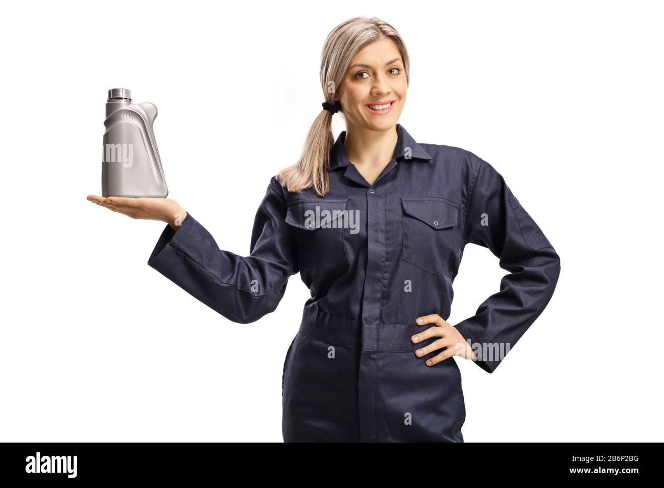 Female auto mechanic holding a bottle of motor oil isolated on white ...