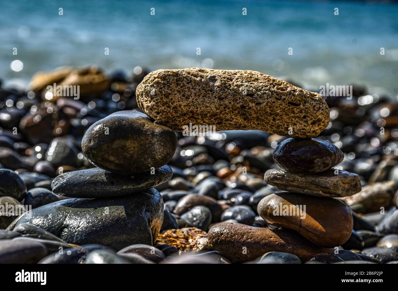 Seascape, pebble beach pyramids on the seashore. Travel and adventure ...