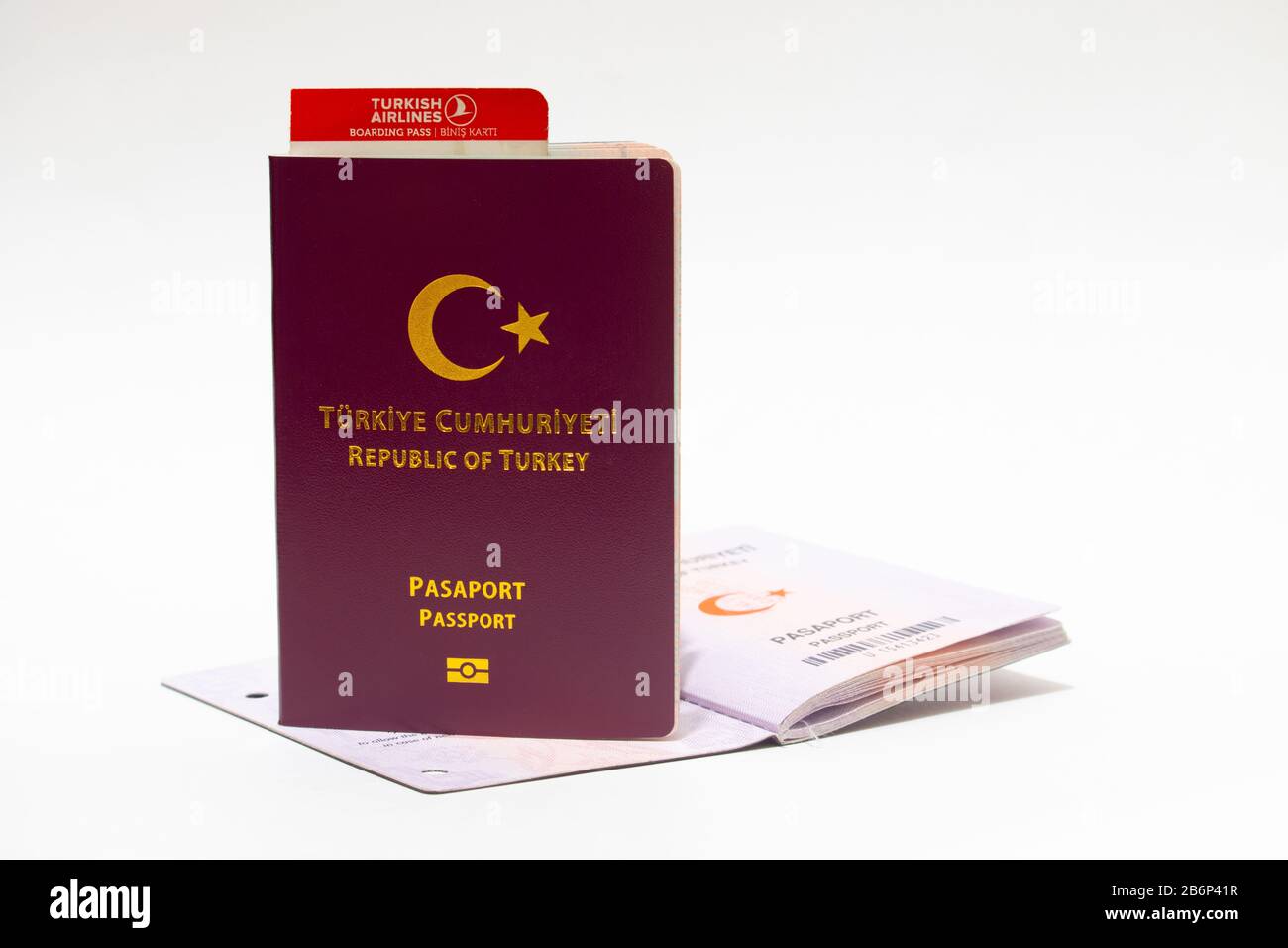 New design Turkish passport with plane travel ticket on white isolated ...