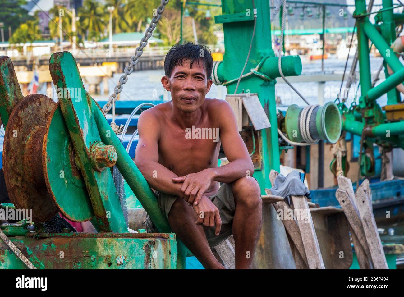 Filipino fisherman on his fishing boat at Sandakan harbour Sabah ...