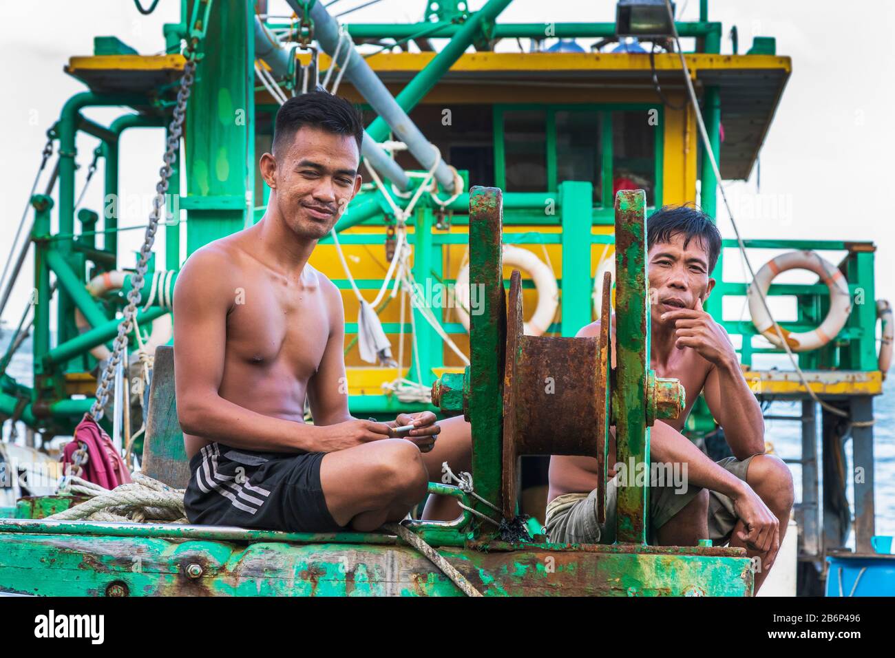 Filipino fishermen on their fishing boat at Sandakan harbour Sabah ...
