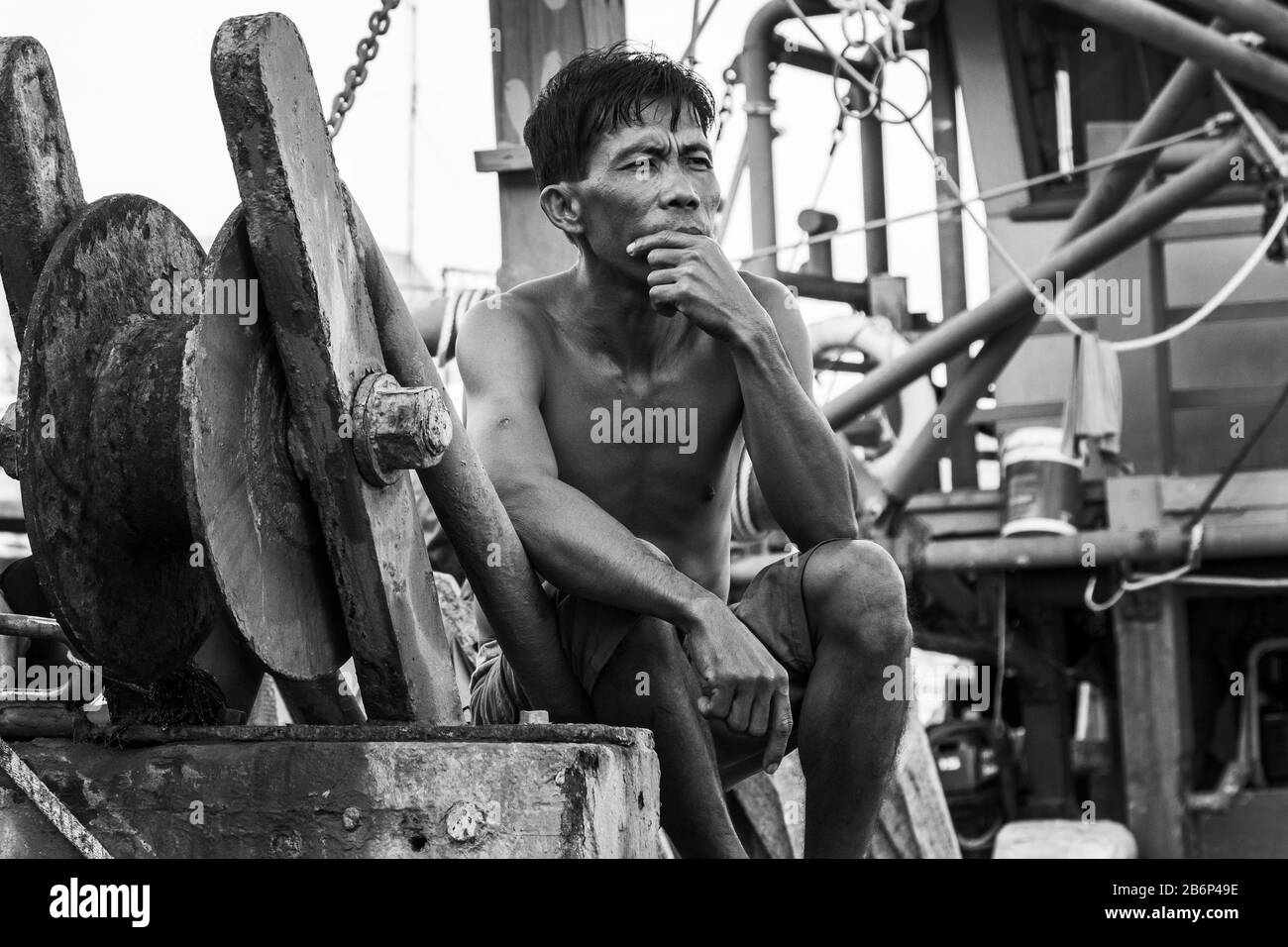 Filipino fisherman on his fishing boat at Sandakan harbour Sabah ...
