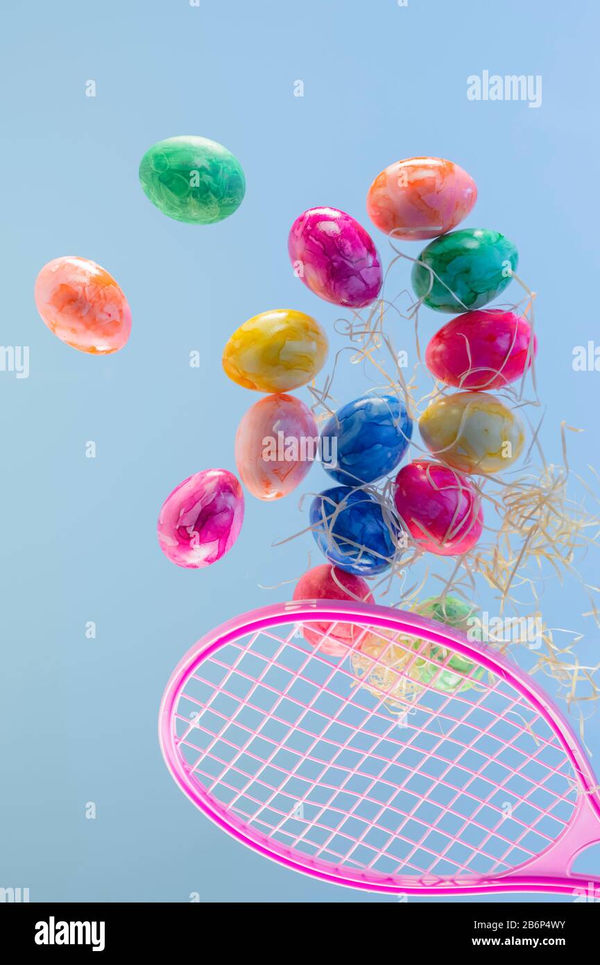 Easter eggs being launched by a tennis racket Stock Photo - Alamy