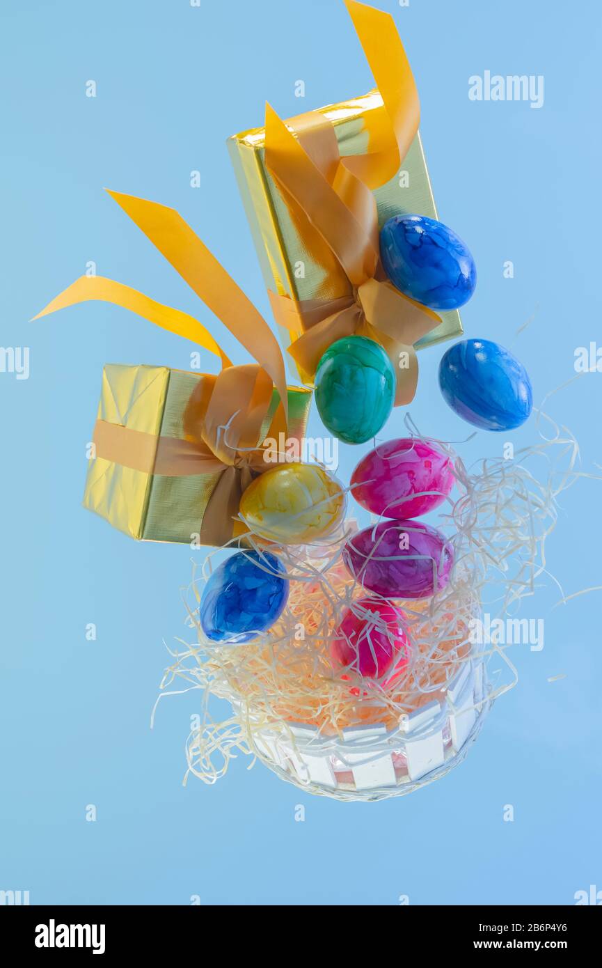 Wooden basket with floating gift boxes and easter eggs Stock Photo - Alamy