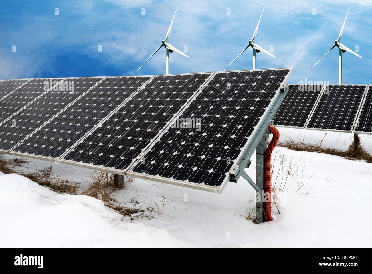 Photo collage of solar panels and wind turbins in winter with snow ...