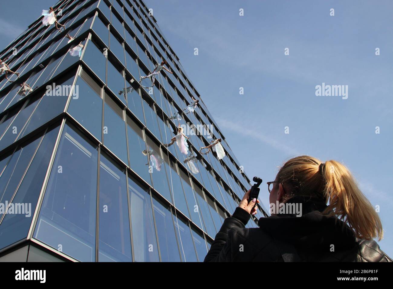 New York, USA. 11th Mar, 2020. A woman photographs the performers on ...